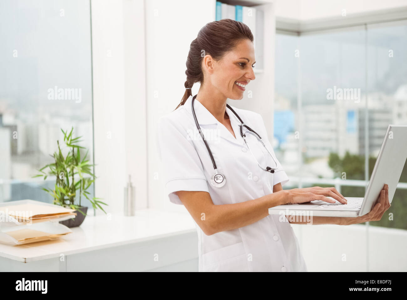 Female doctor using laptop in medical office Stock Photo - Alamy