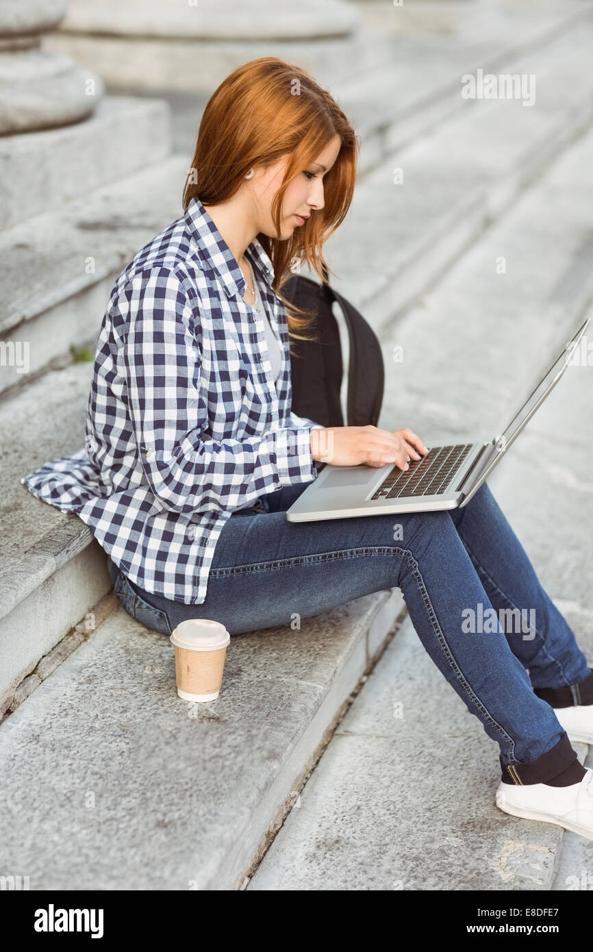 Young student using her laptop to study outside Stock Photo - Alamy