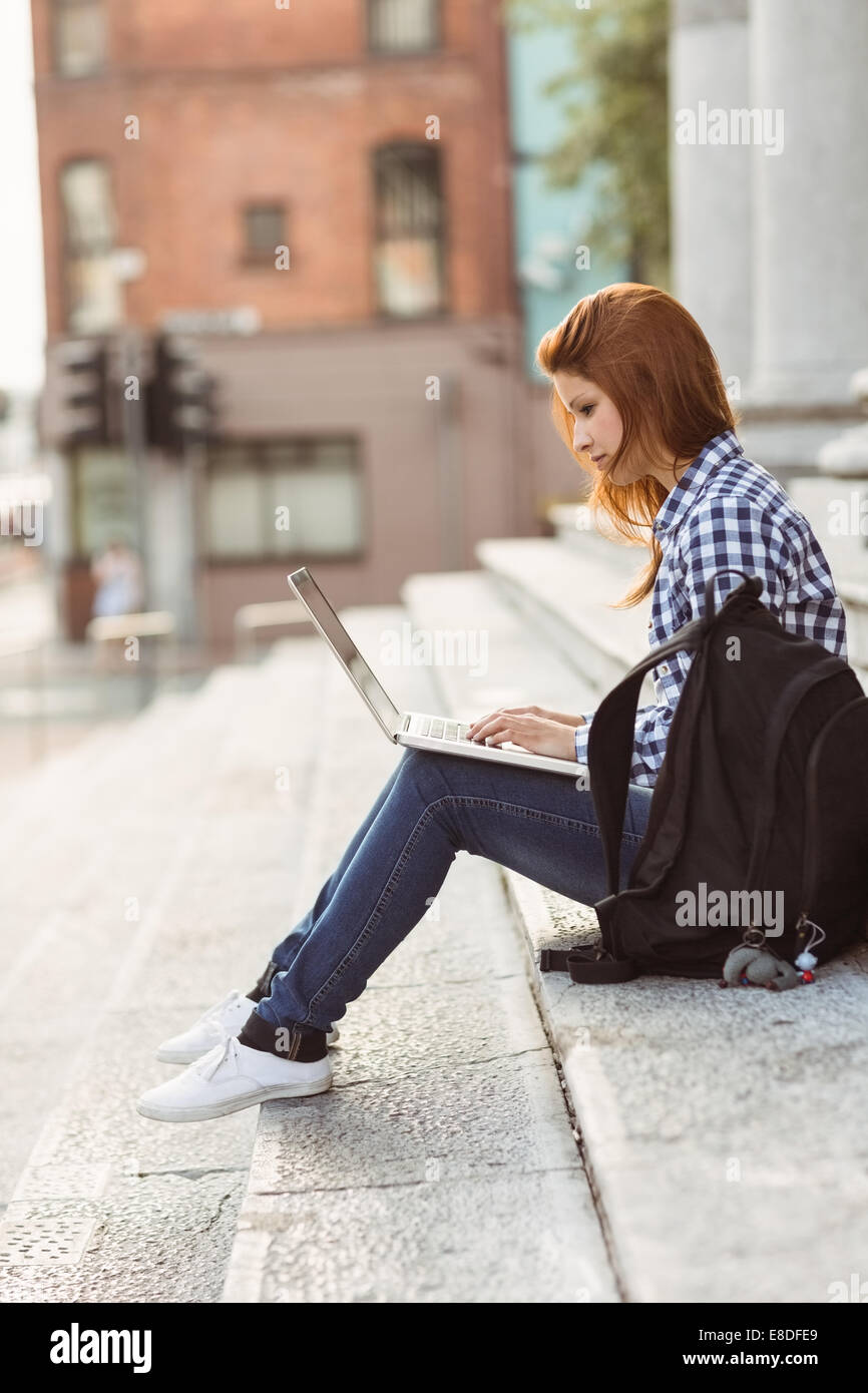 Young student using her laptop to study outside Stock Photo - Alamy
