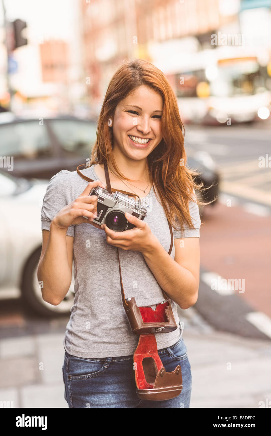 Cheerful photographer standing outside smiling at camera Stock Photo ...