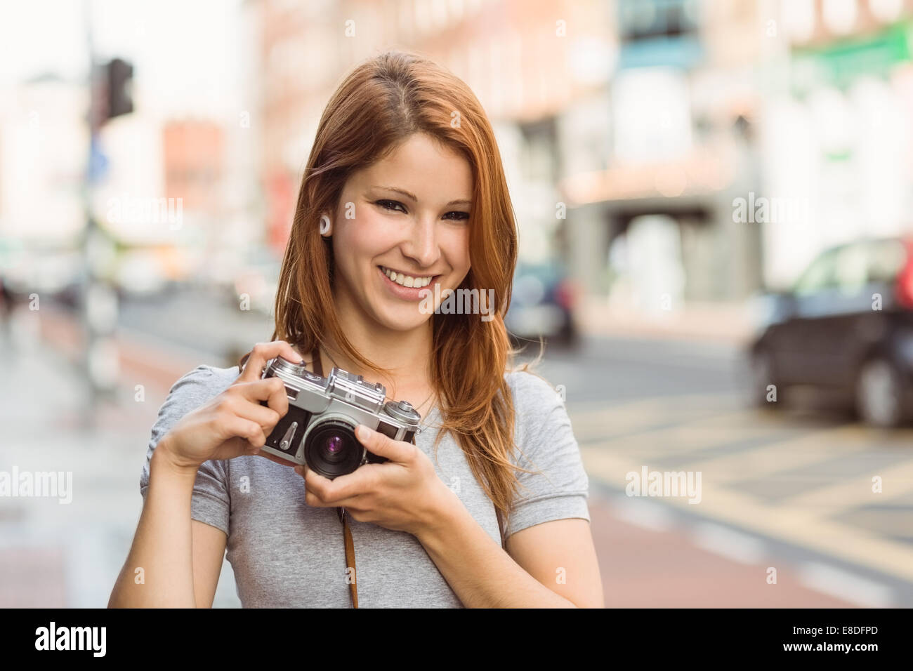Cheerful photographer standing outside smiling at camera Stock Photo ...