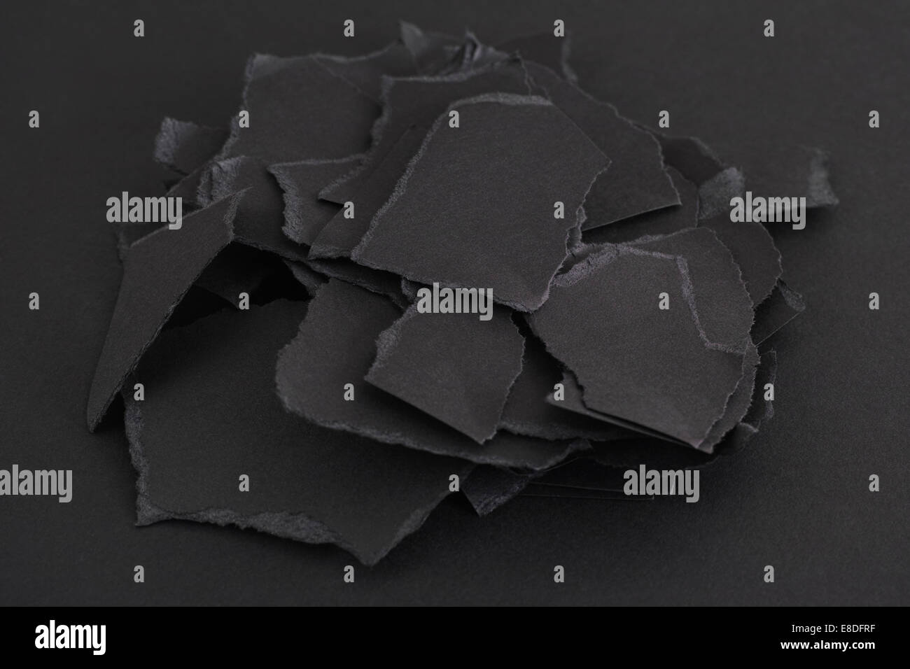 Torn pieces of black paper on a black background Stock Photo - Alamy