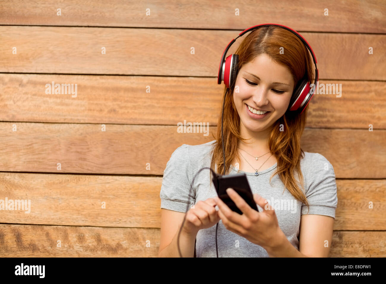 Girl listening music with headphones while sending message Stock Photo ...