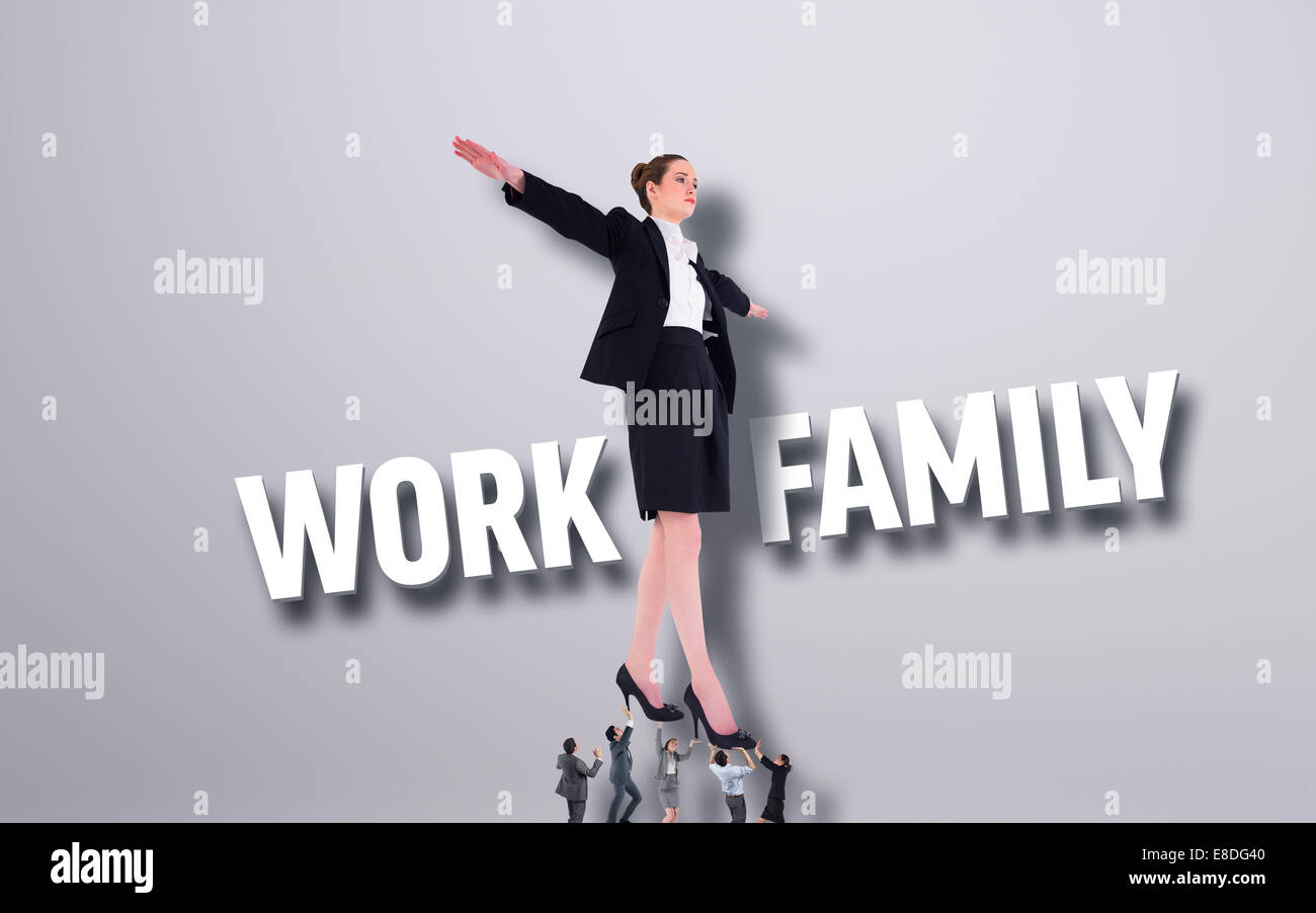 Composite image of business people supporting boss Stock Photo - Alamy