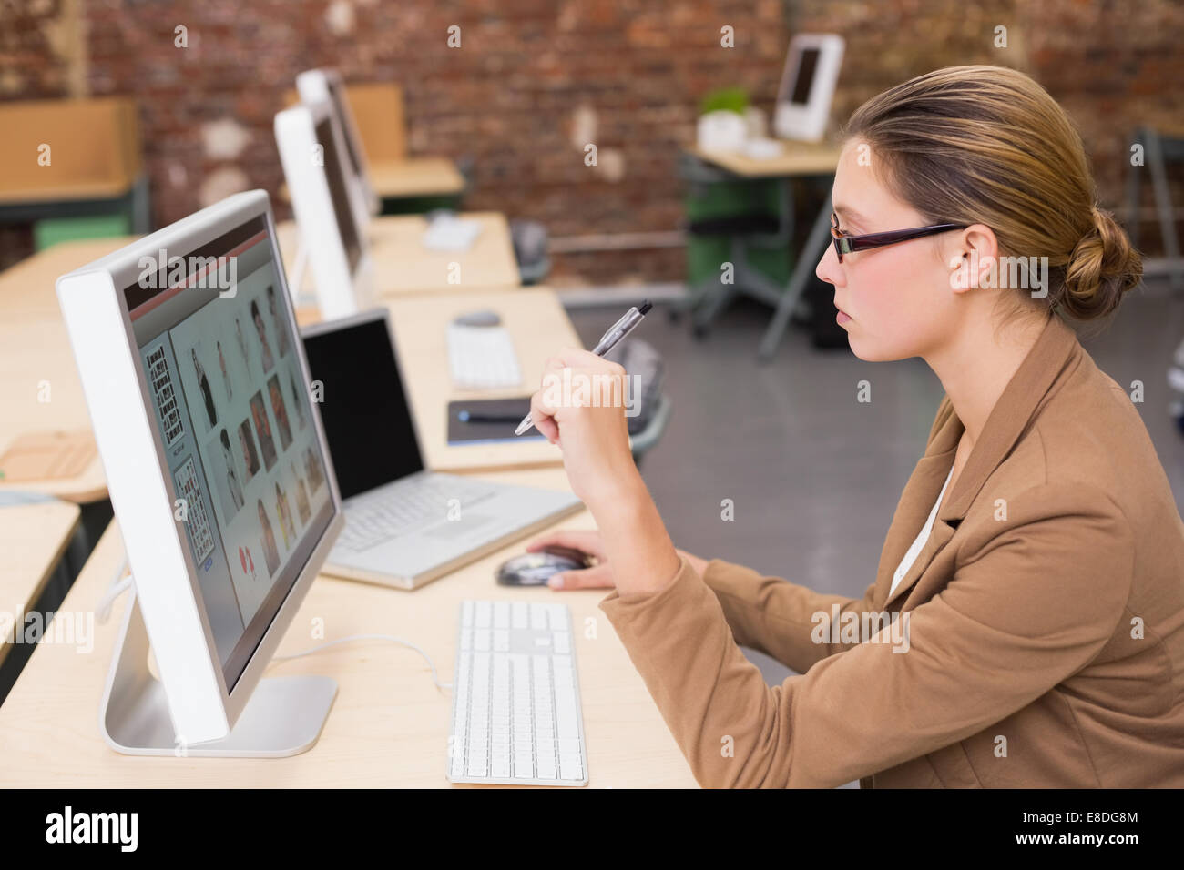 Businesswoman using computer at office desk Stock Photo - Alamy