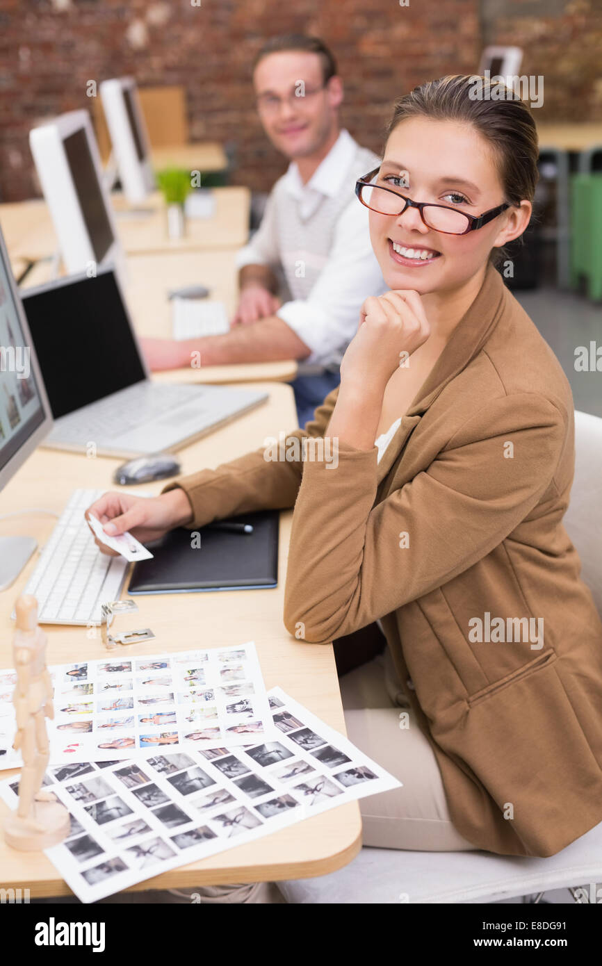 Smiling photo editors using computers in office Stock Photo - Alamy