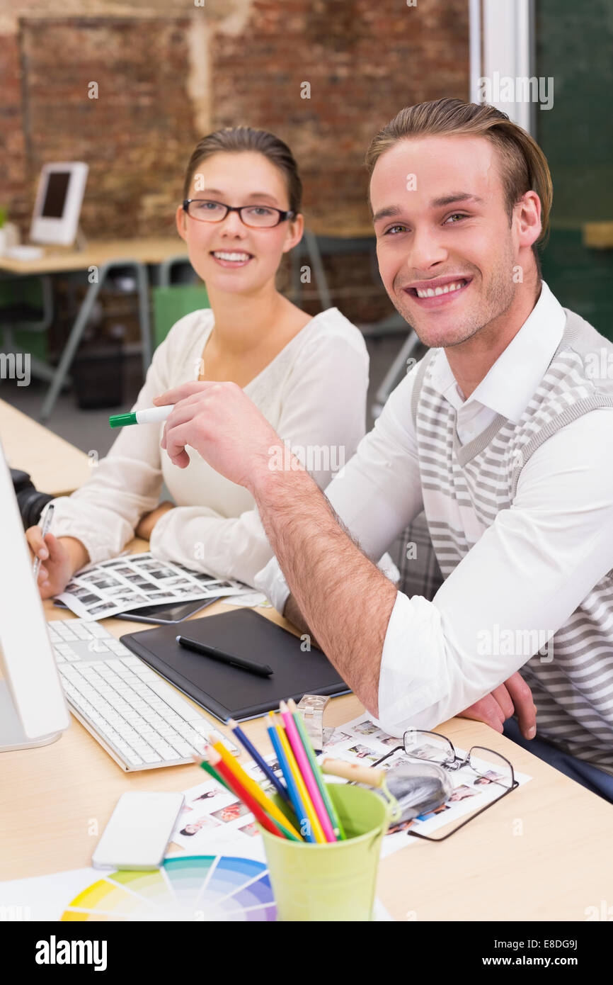 Smiling photo editors at work in office Stock Photo - Alamy