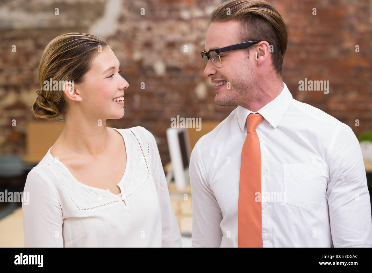 Two young smiling colleagues hi-res stock photography and images - Alamy