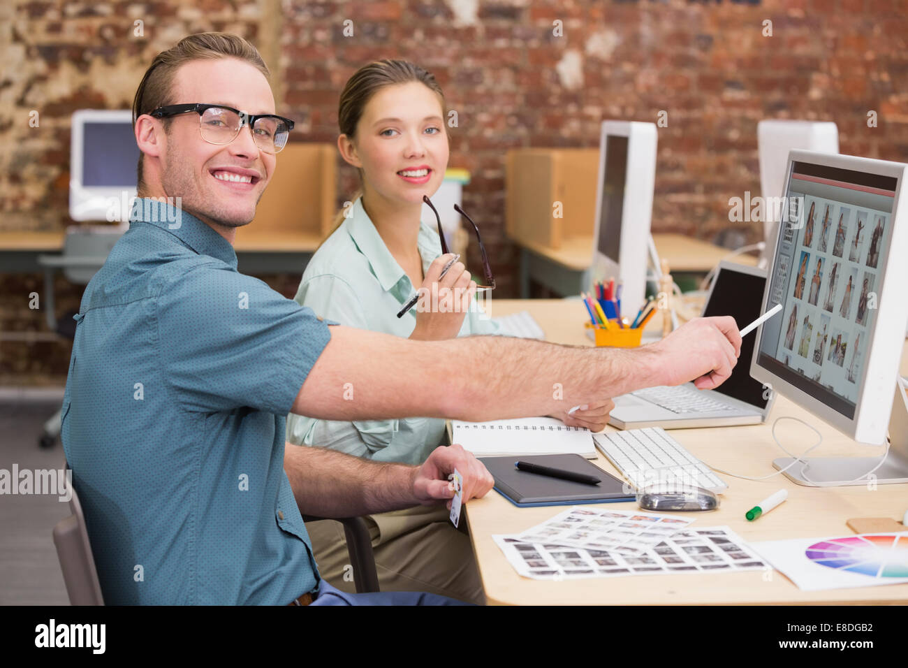 Casual photo editors using computer in office Stock Photo - Alamy