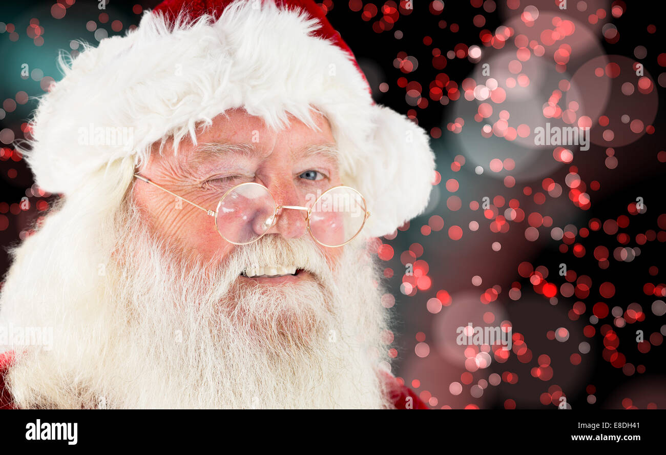 Composite image of santa claus winking Stock Photo - Alamy