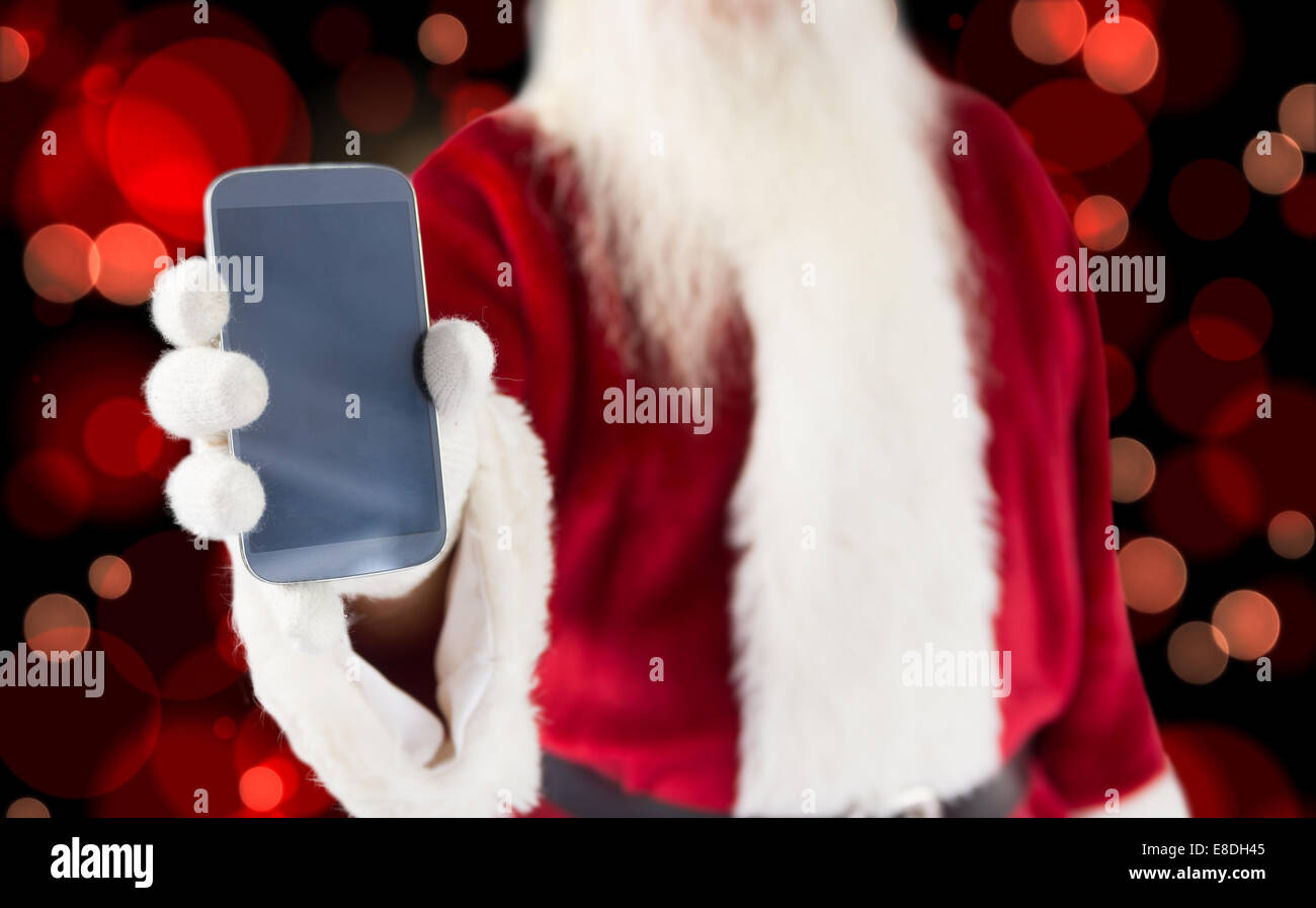 Composite image of santa claus showing smartphone Stock Photo - Alamy