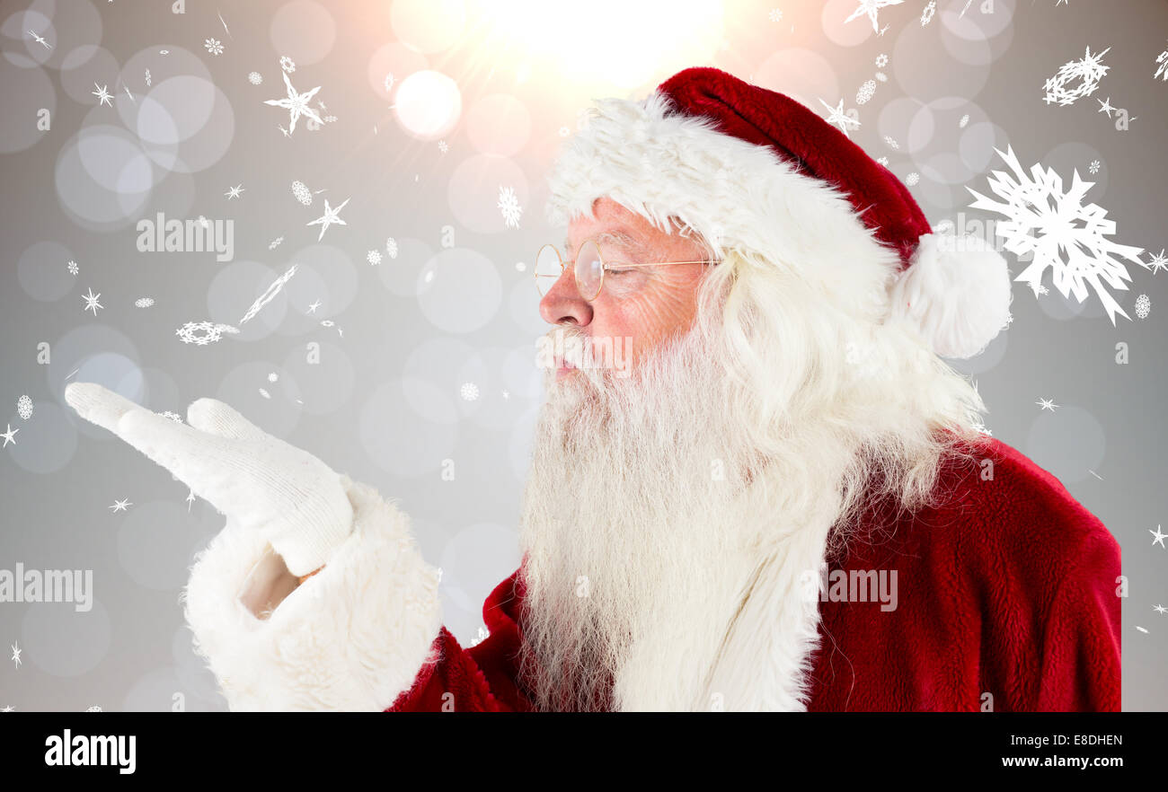 Composite image of santa claus blowing Stock Photo - Alamy