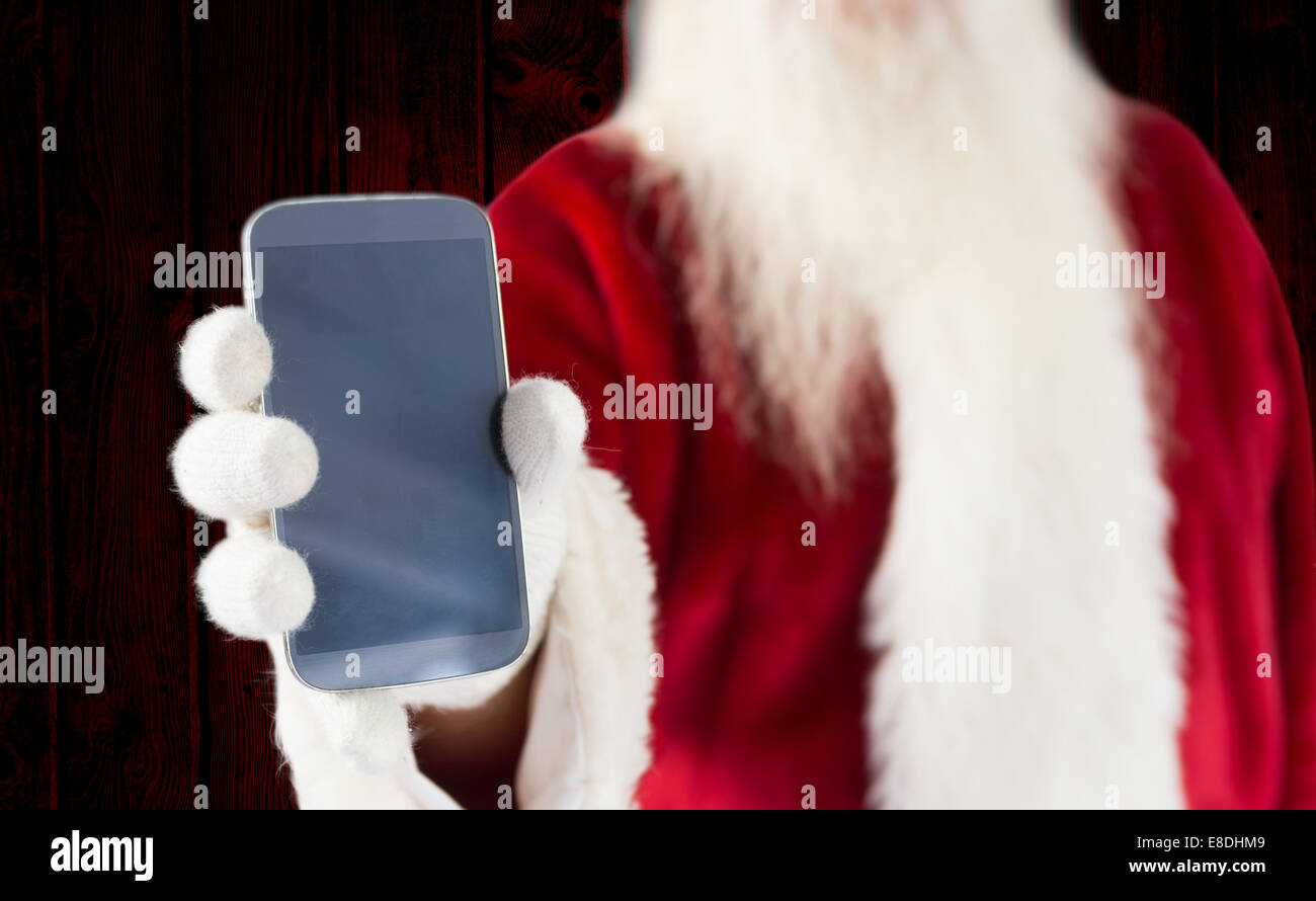 Composite image of santa claus showing smartphone Stock Photo - Alamy