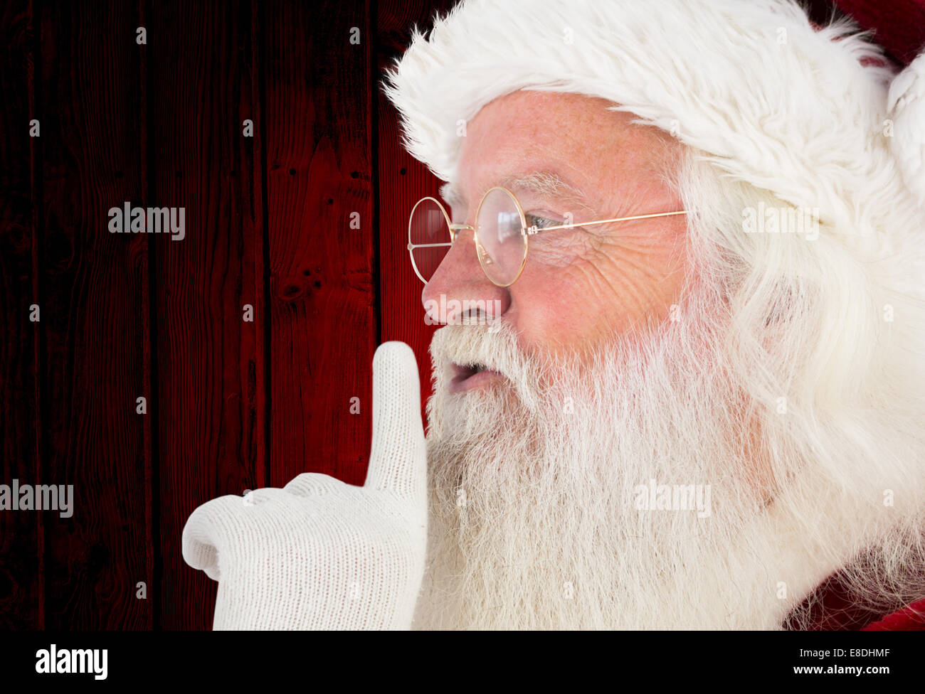 Composite image of santa claus making quiet sign Stock Photo - Alamy