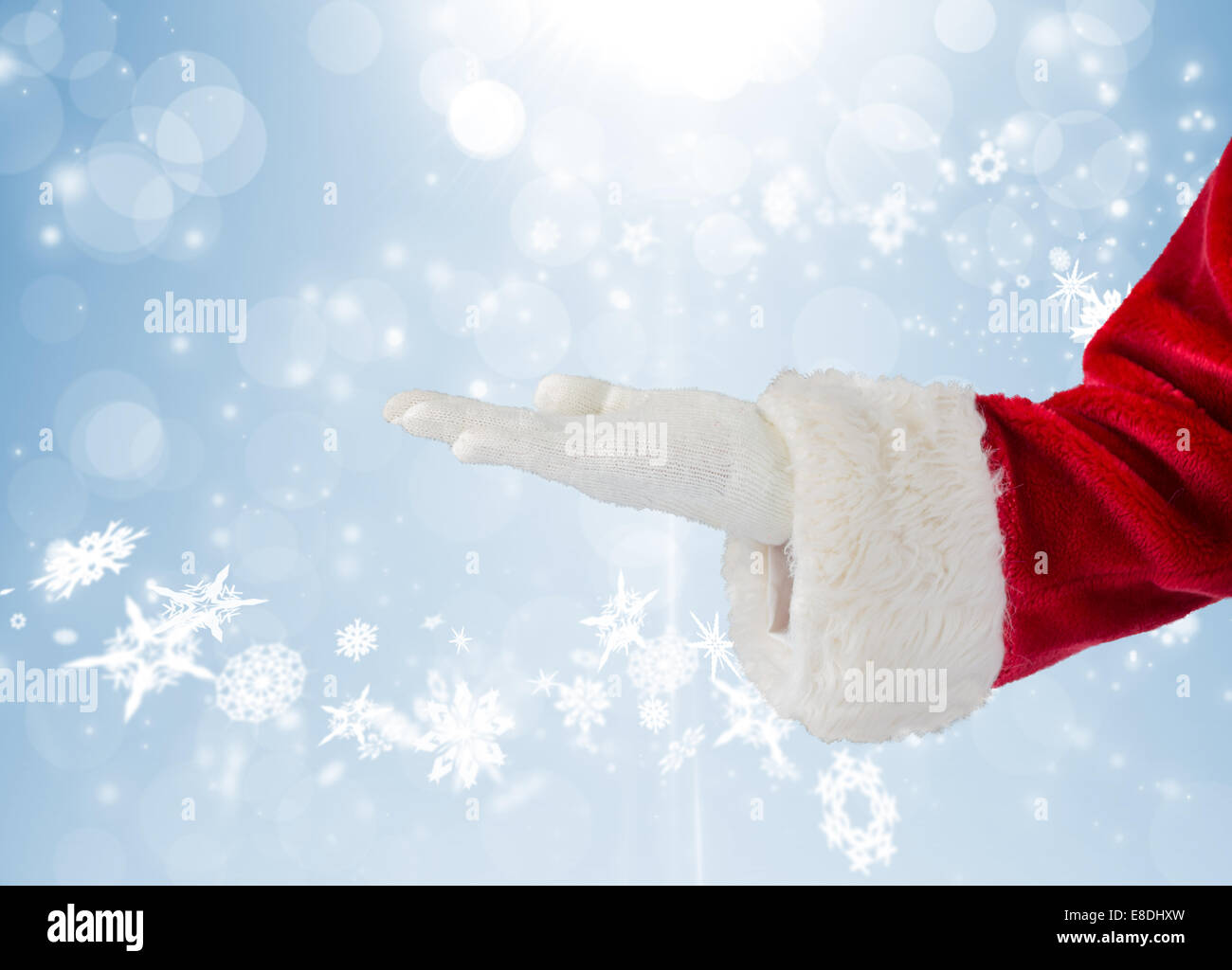 Composite image of santa claus presenting with hand Stock Photo - Alamy