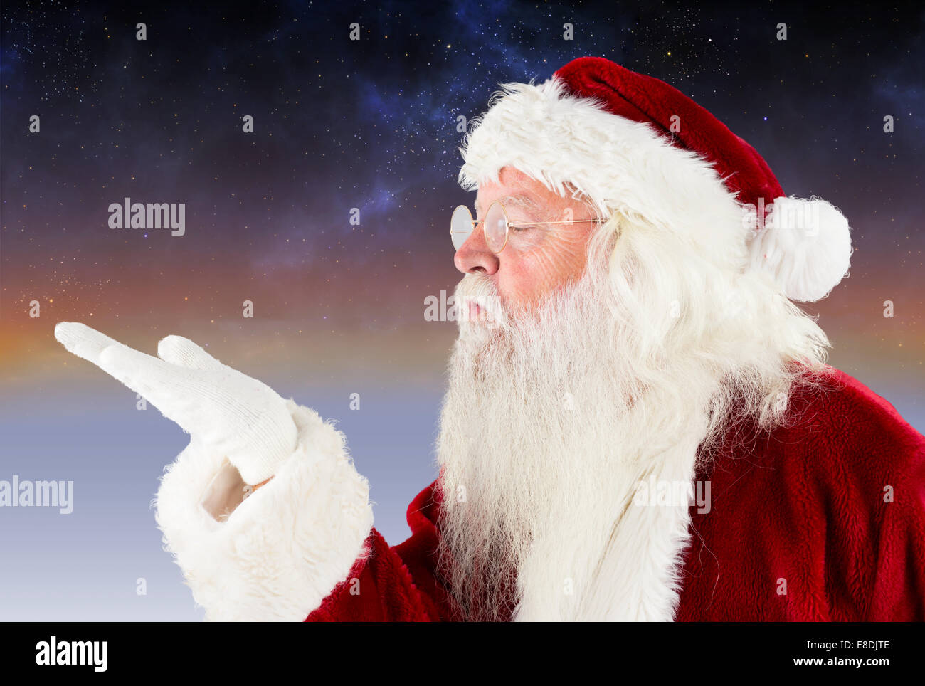 Composite image of santa claus blowing Stock Photo - Alamy