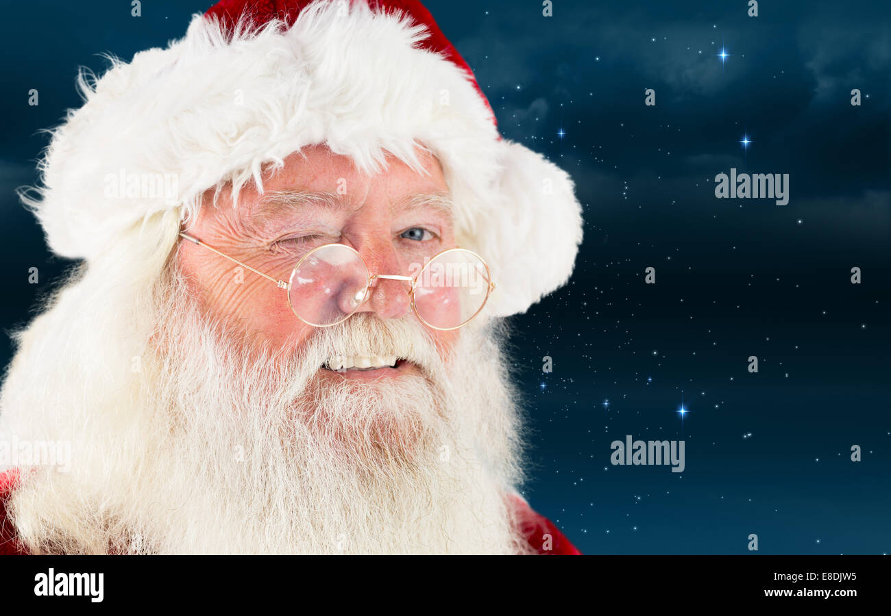 Composite image of santa claus winking Stock Photo - Alamy