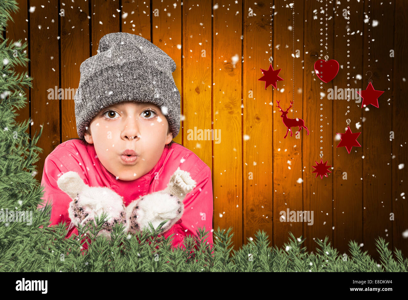 Composite image of wrapped up little girl blowing over hands Stock ...