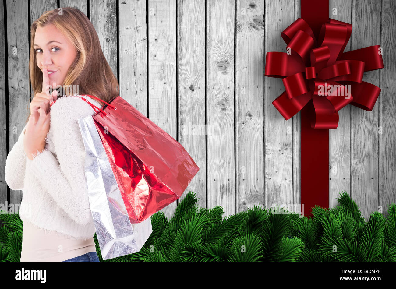 Composite image of pretty blonde keeping a secret holding bags Stock ...