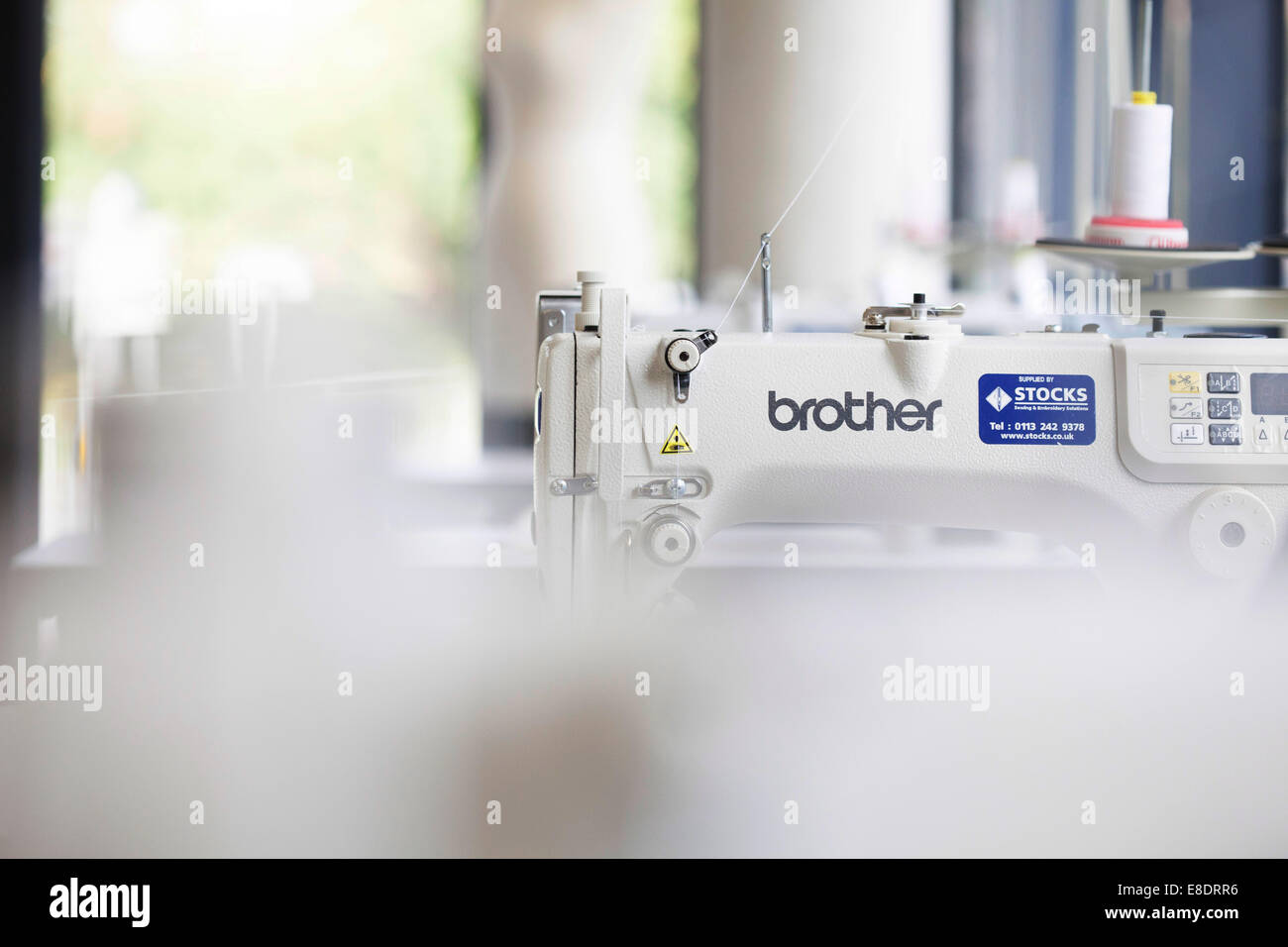 cotton reel on a sewing machine Stock Photo - Alamy