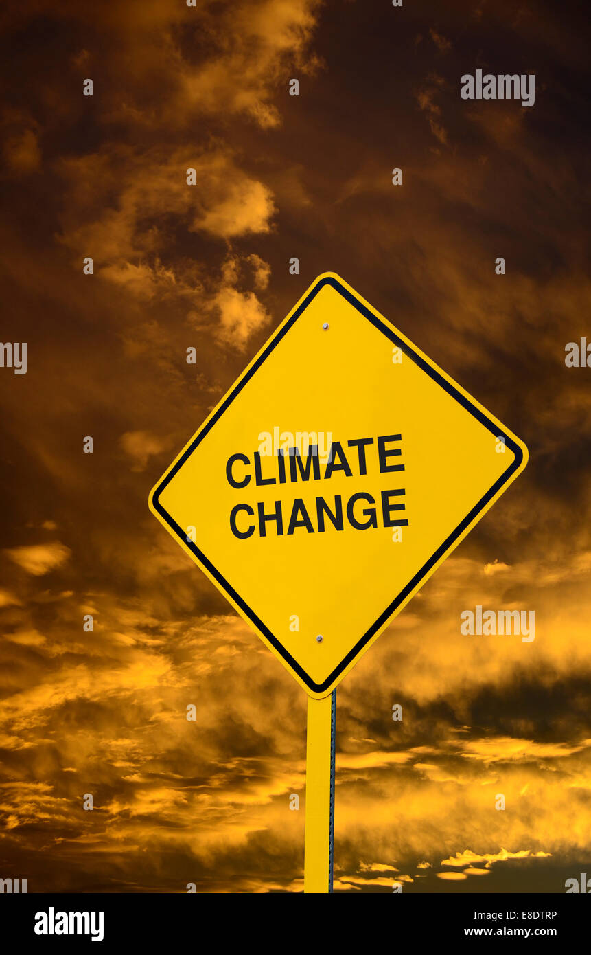 A Caution Sign in front of dramatic yellow storm clouds warning of ...