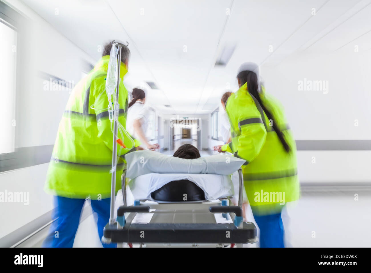 Motion blurred photo of patient on stretcher gurney pushed at speed ...