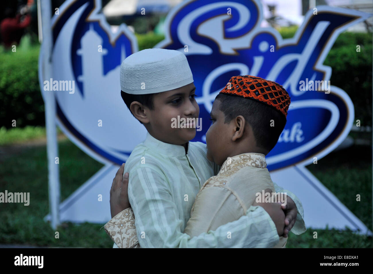 Children hug each other after offering a prayer during the Eid al-Adha ...