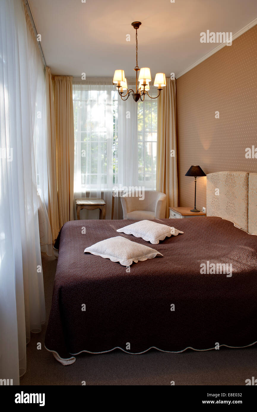 Narrow classic style hotel room with big windows Stock Photo - Alamy