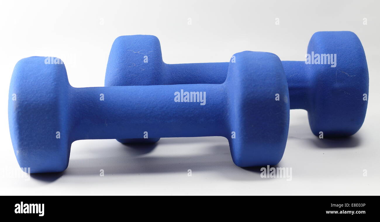 Blue weights on a white background Stock Photo - Alamy