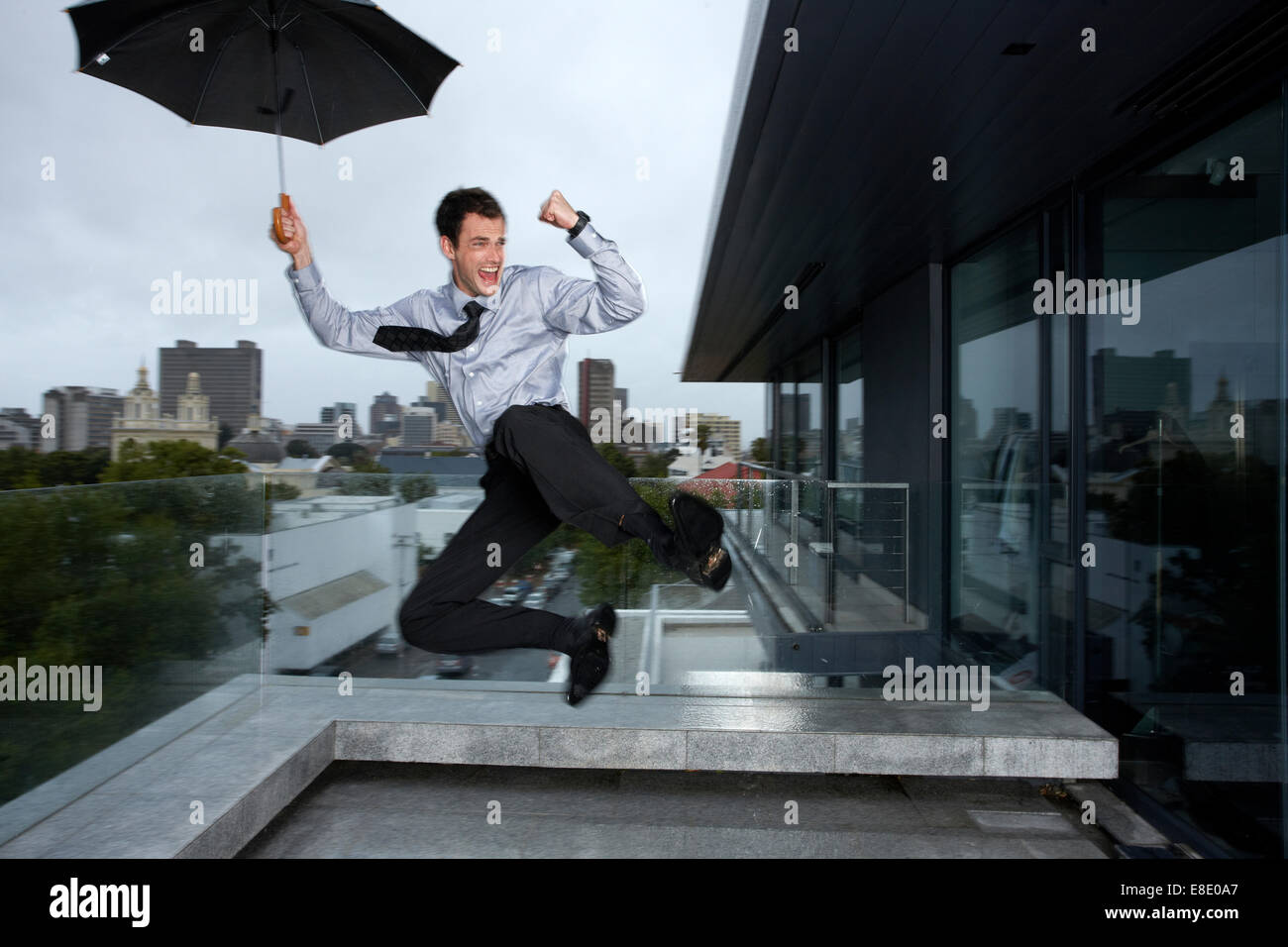 Man umbrella jumping in rain hi-res stock photography and images - Alamy