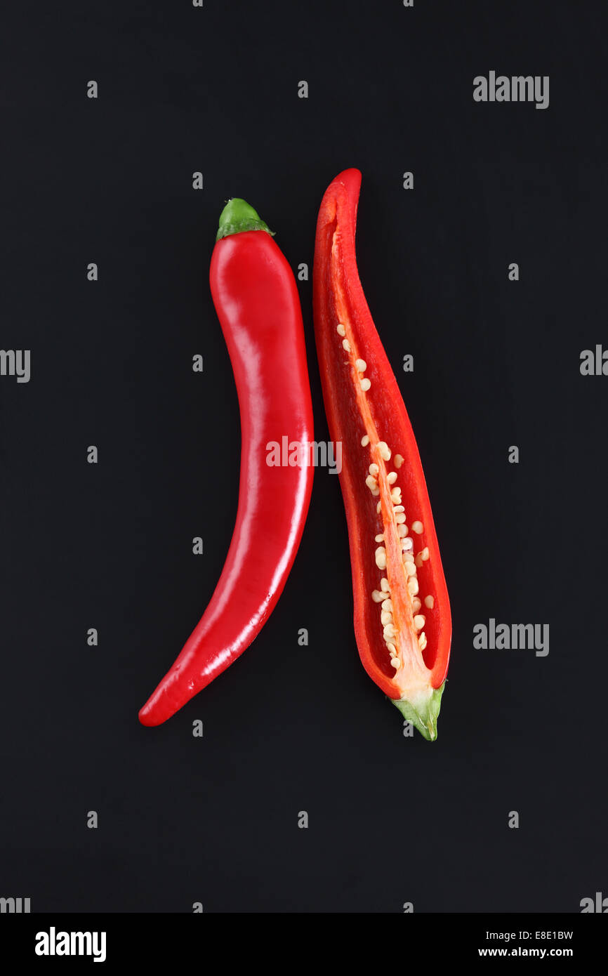 Red chili peppers on black background Stock Photo - Alamy