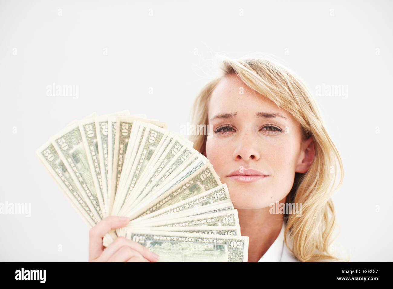 Woman with a money fan Stock Photo - Alamy