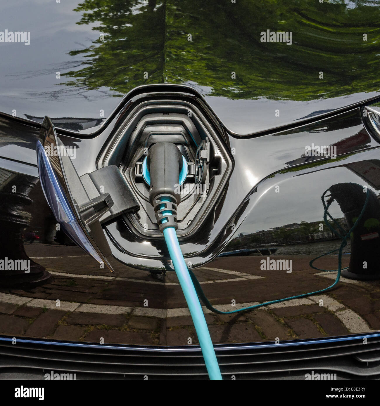 Charging modern electric car with the power supply plugged in Stock ...