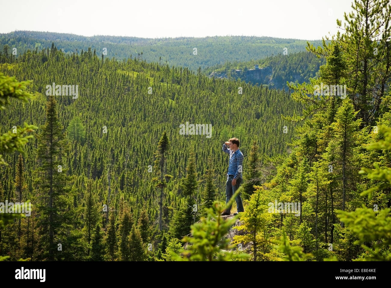 Lost young man on a rock in the middle of the nature Stock Photo - Alamy