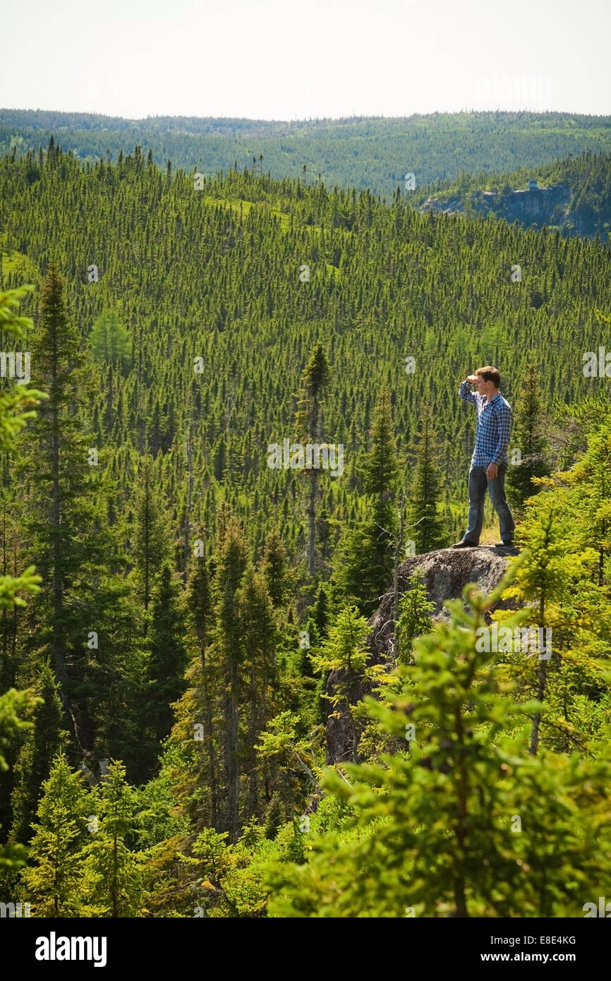 Lost young man on a rock in the middle of the nature Stock Photo - Alamy