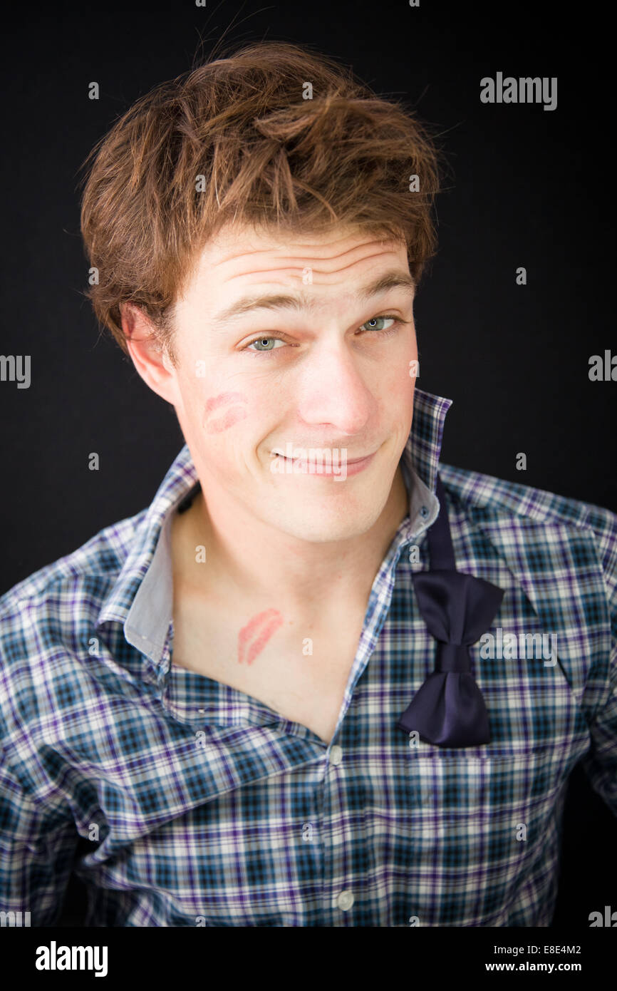 A young man that had some fun and got a kiss trace on the cheek Stock ...