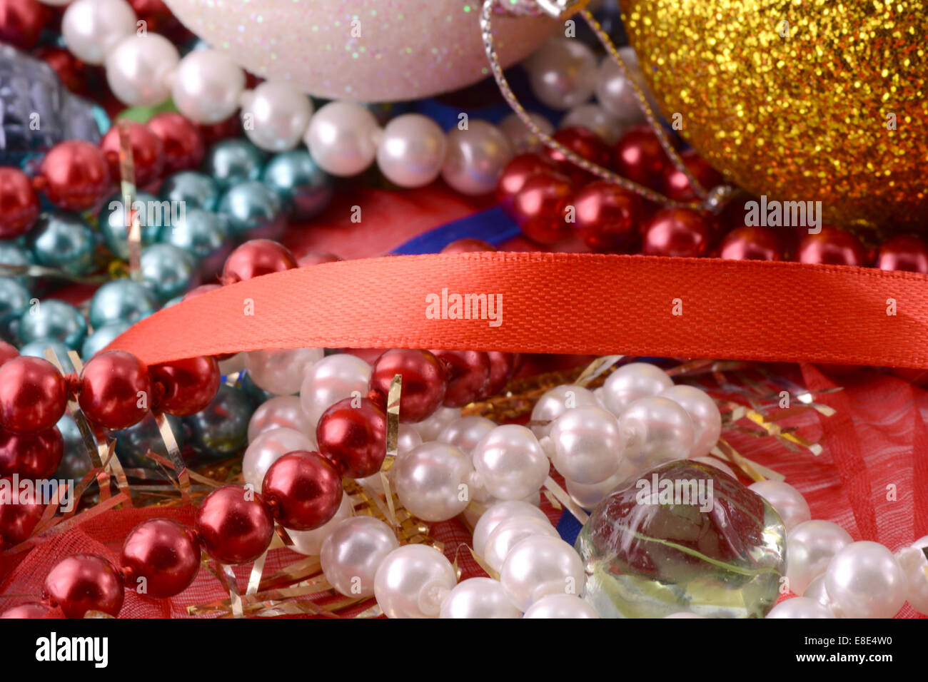 String of pearls on red background Stock Photo - Alamy