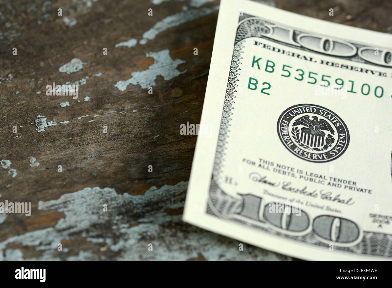 Hundreds of US dollars on old wooden background Stock Photo - Alamy
