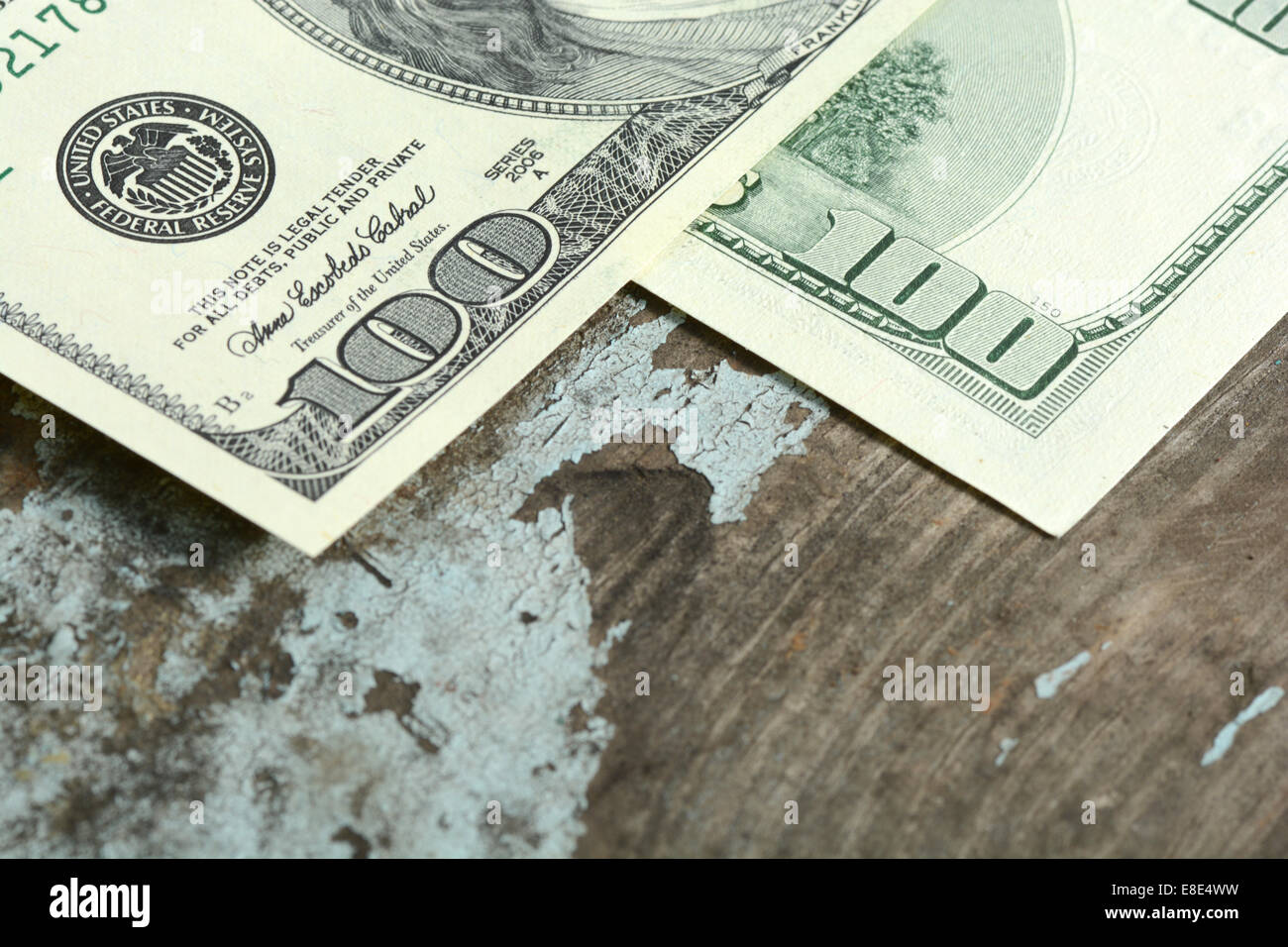 Close-up of a $100 banknotes on wooden background Stock Photo - Alamy