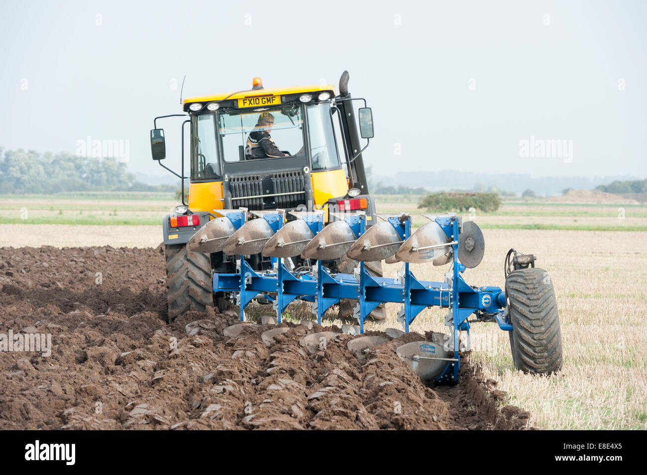 A man ploughing using a tractor in a ploughing match at Cottenham ...