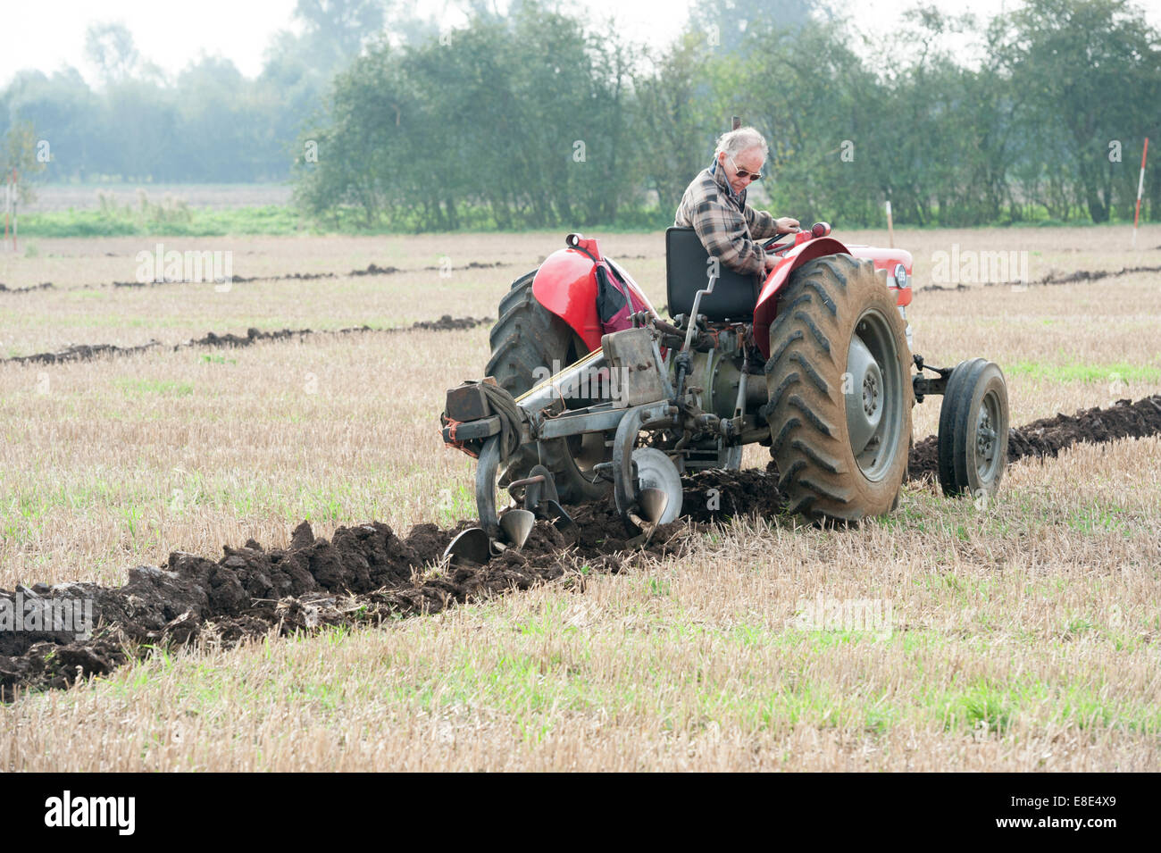 A man ploughing using a tractor in a ploughing match at Cottenham ...