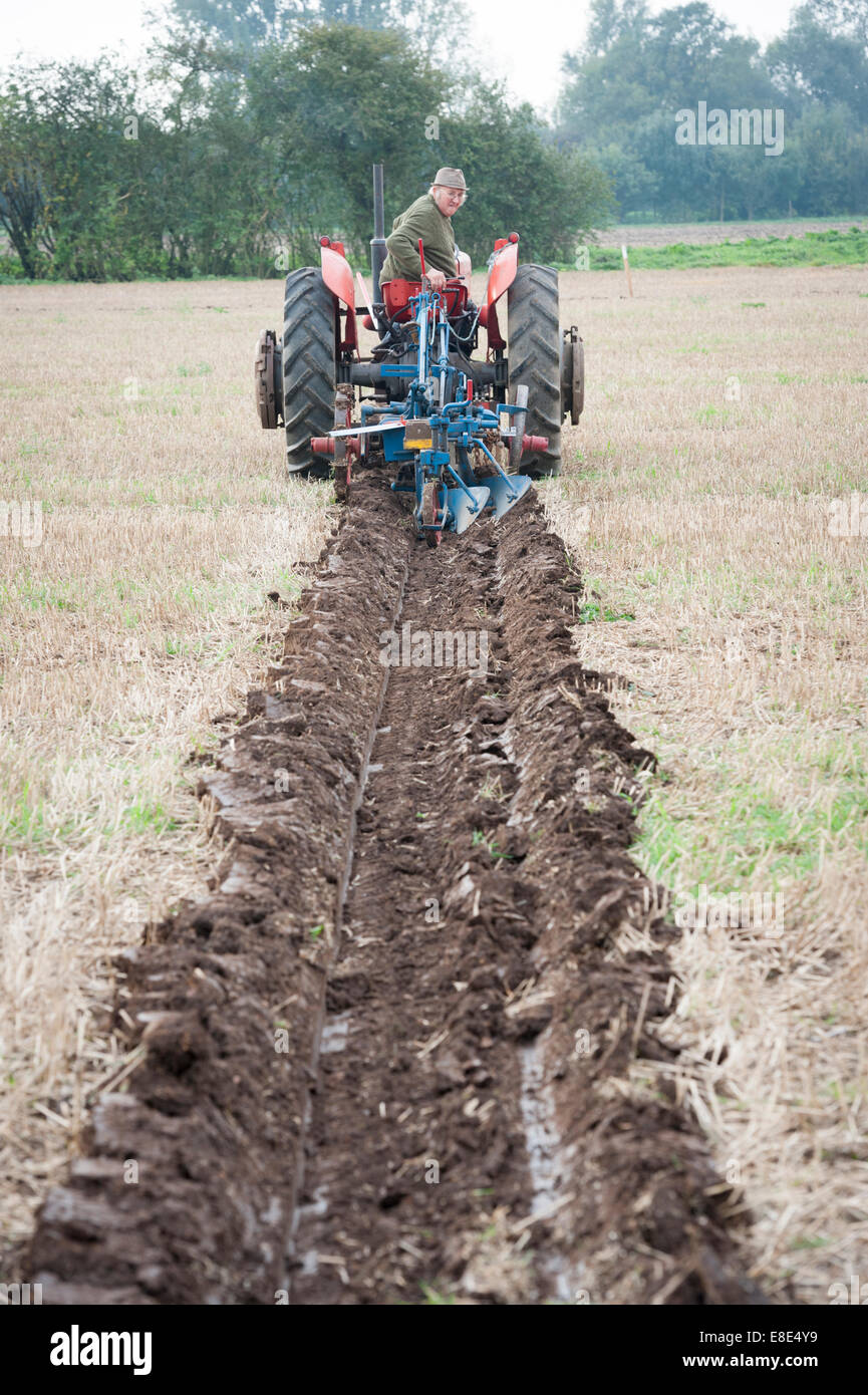 A man ploughing using a tractor in a ploughing match at Cottenham ...