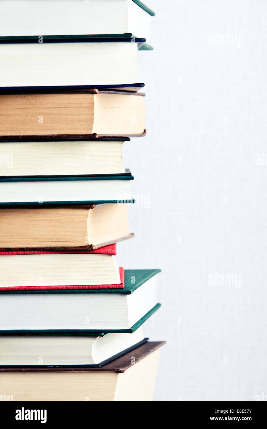 Very high stack of books on the left side Stock Photo - Alamy