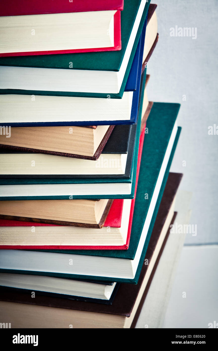 Closeup of a Very high stack of books on a table Stock Photo - Alamy