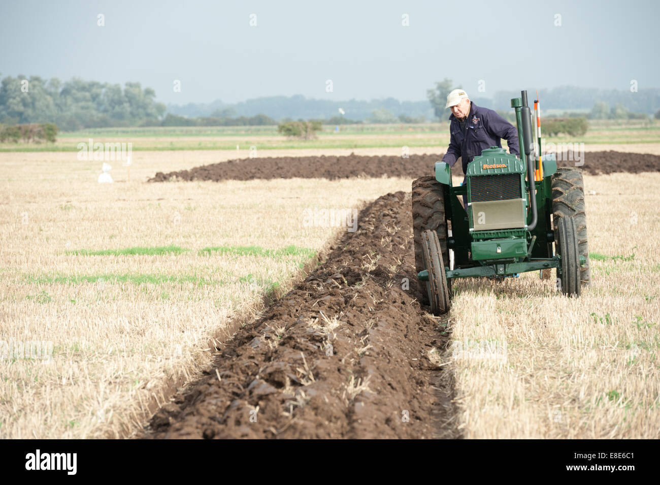 A man ploughing using a tractor in a ploughing match at Cottenham ...