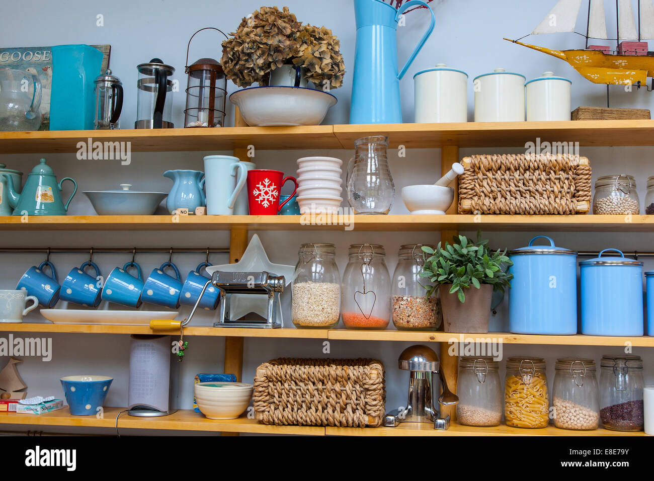 Shelves stocked with jars and containers in a cottage kitchen Stock ...