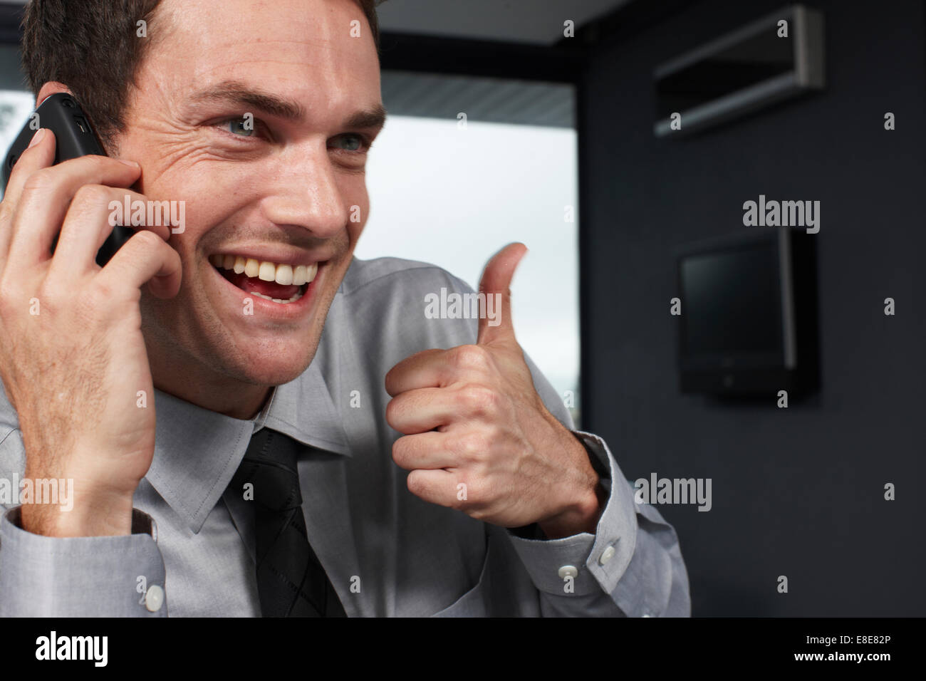 Young businessman doing OK sign Stock Photo - Alamy