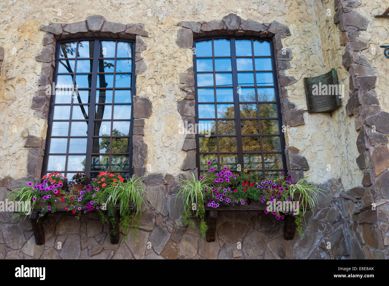 beautiful windows in the city with colorful flowers Stock Photo - Alamy