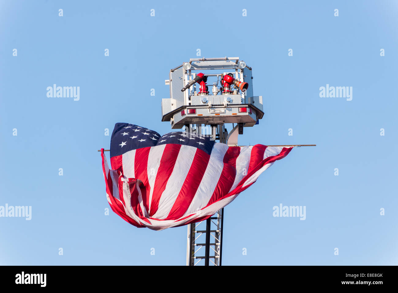 An American Flag is flying from an extended fire department ladder ...