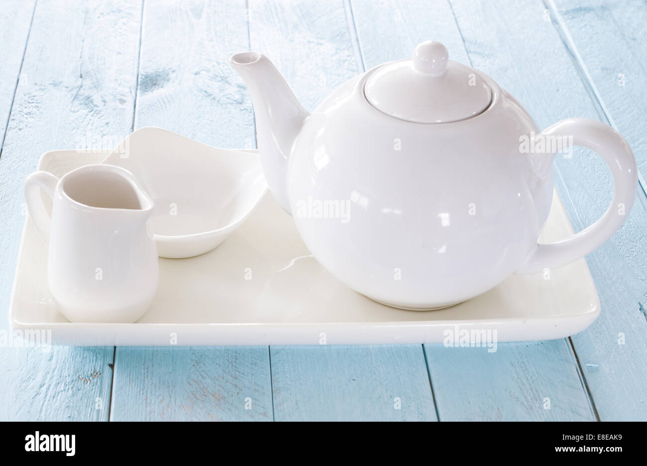 White tea set with high key lighting on vintage wood surface Stock ...